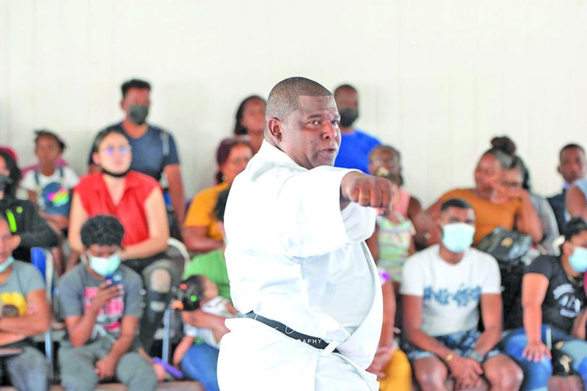 Assistant Superintendent Beaton poses with 2 new medals - Guyana Times