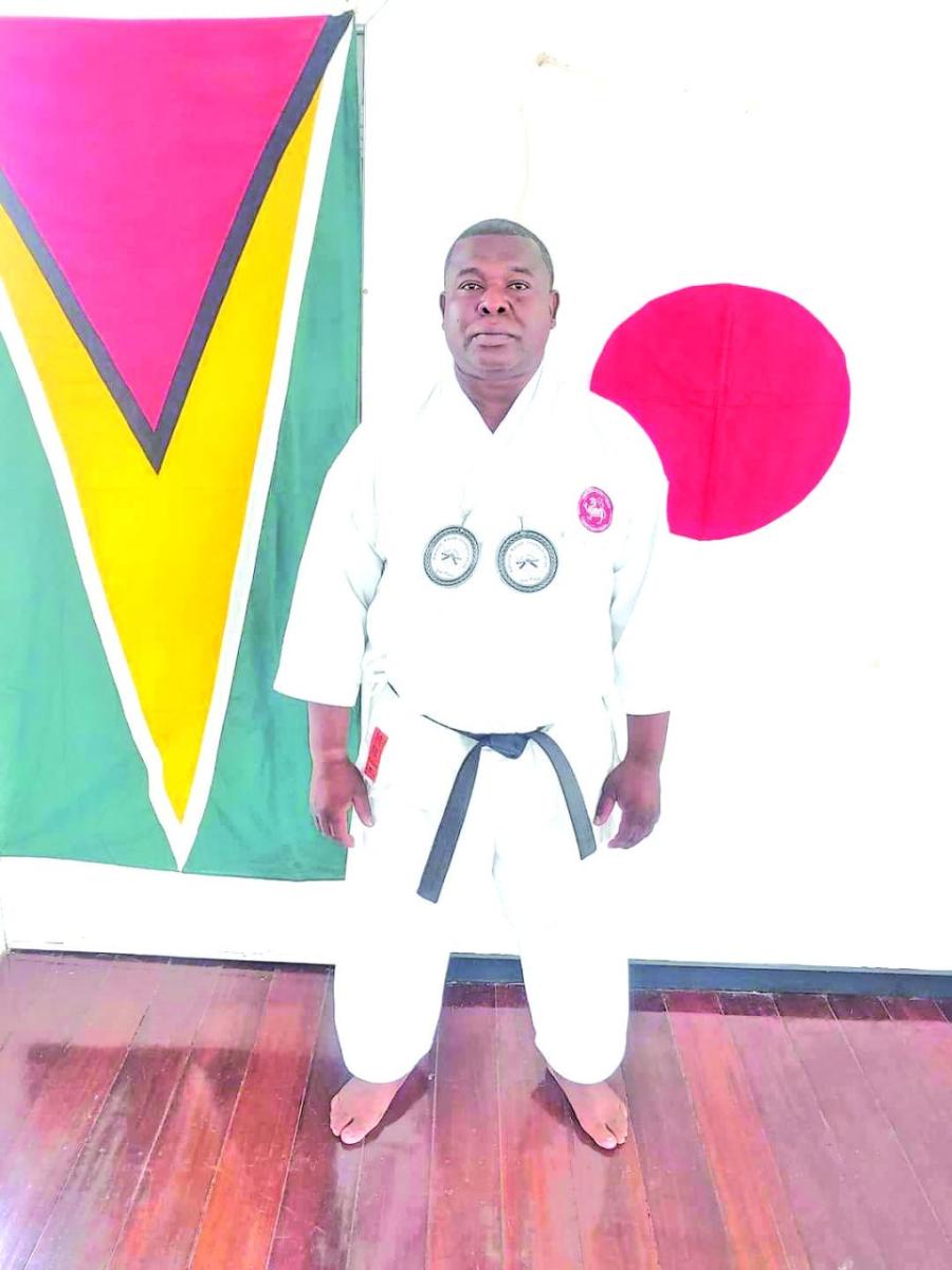 Assistant Superintendent Beaton poses with 2 new medals - Guyana Times