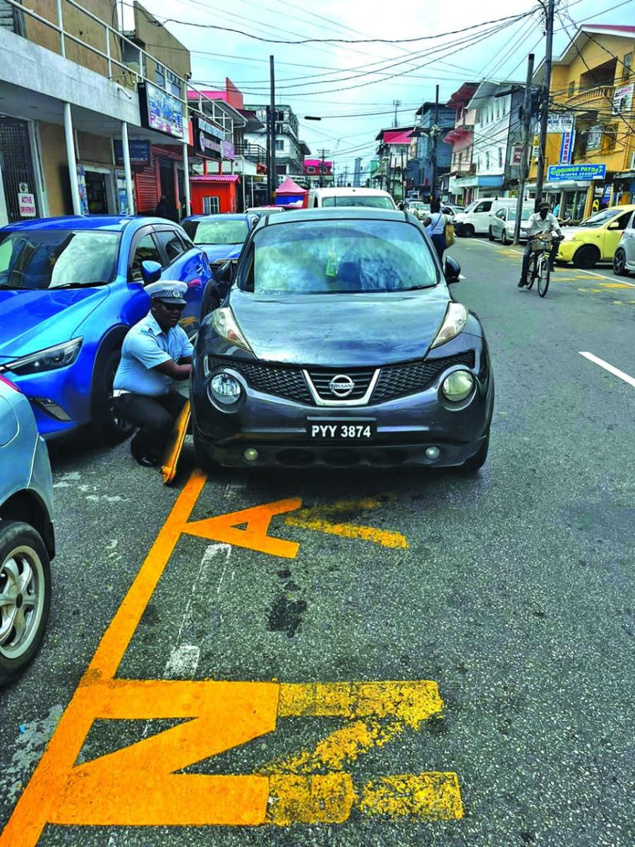 Parked vehicles obstructing traffic clamped; tickets issued - Guyana Times