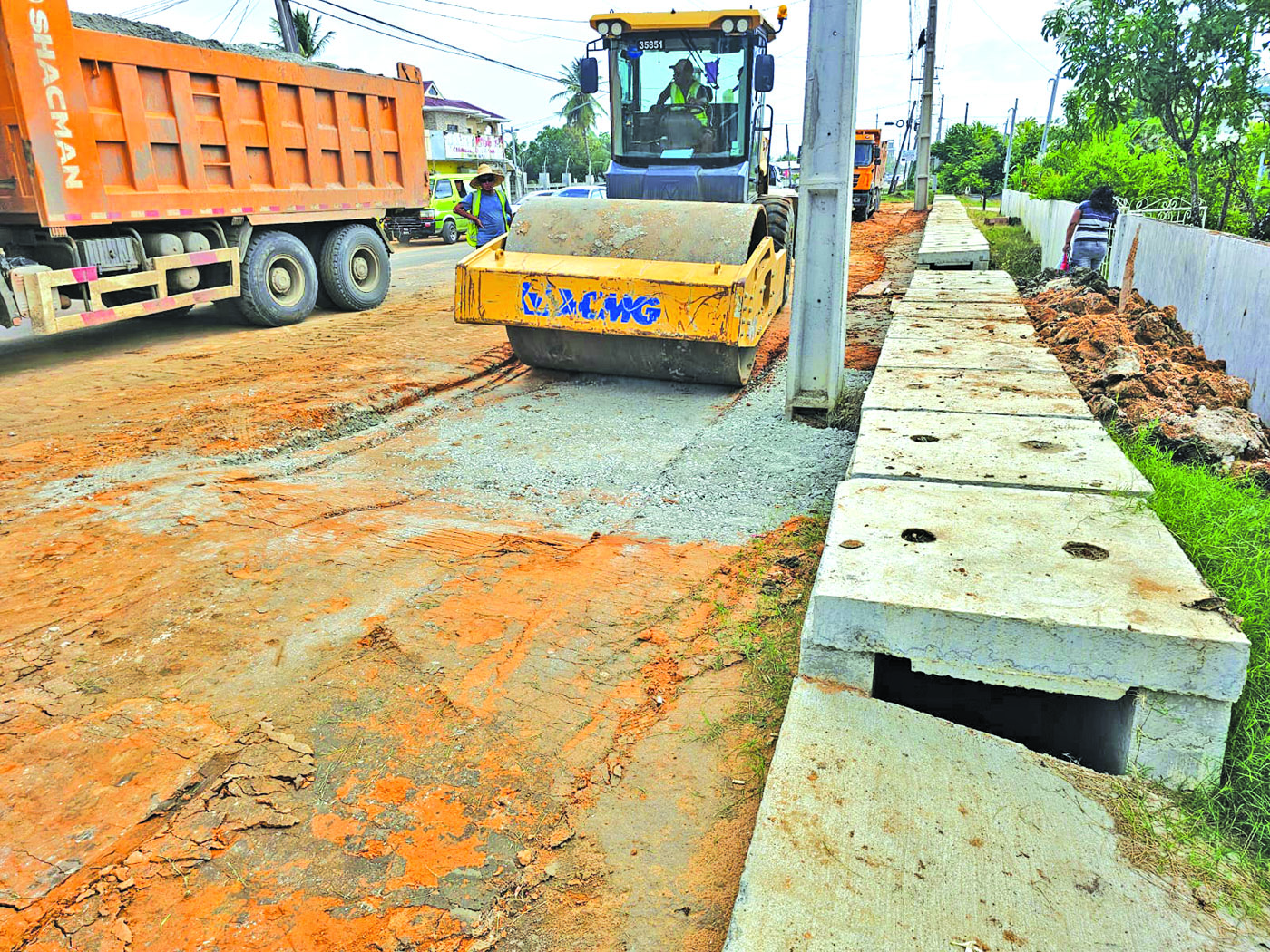 Contractors reinforcing concrete utility poles along ECD - Guyana Times